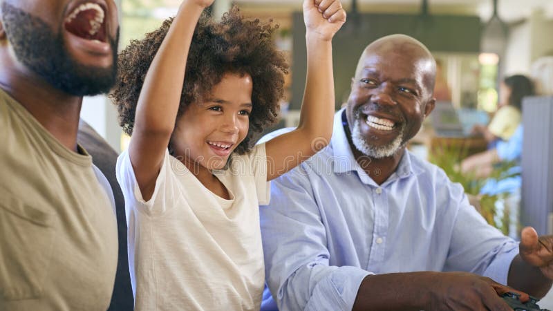 Multi-Generation Male Family Having Fun Playing Computer Game at Home ...