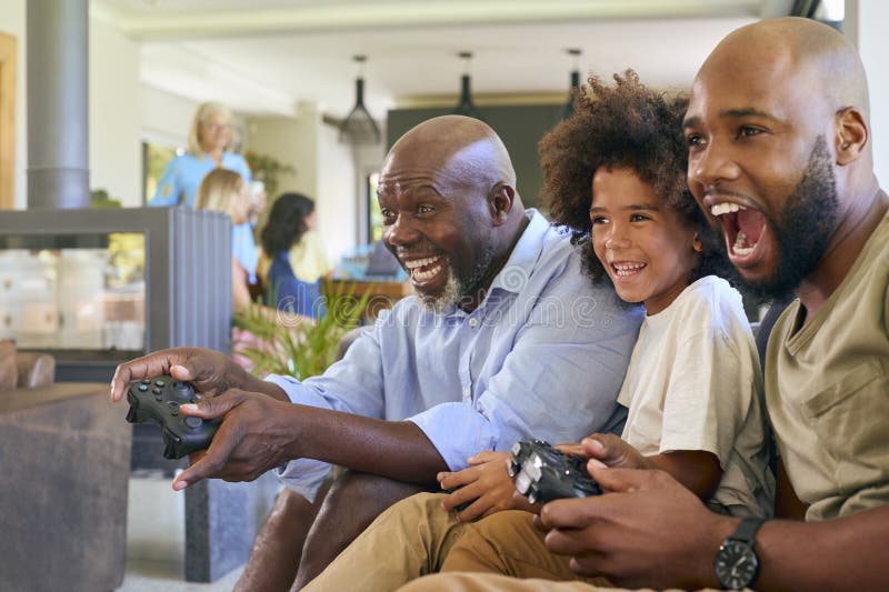 Multi-Generation Male Family Having Fun Playing Computer Game Sitting ...