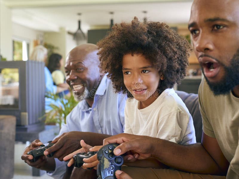 Multi-Generation Male Family Having Fun Playing Computer Game Sitting ...