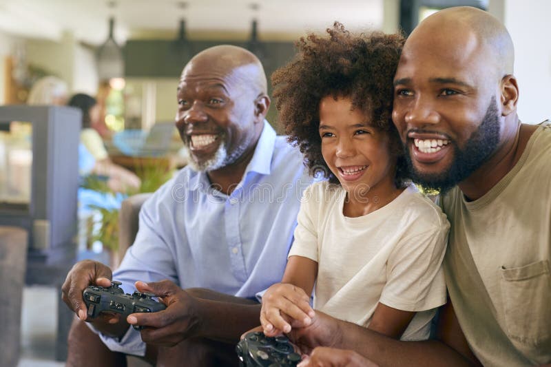 Multi-Generation Male Family Having Fun Playing Computer Game Sitting ...