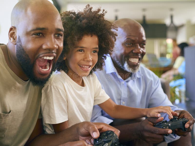 Multi-Generation Male Family Having Fun Playing Computer Game Sitting ...