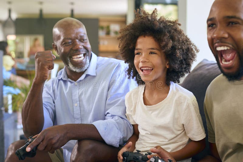 Multi-Generation Male Family Having Fun Playing Computer Game Sitting ...