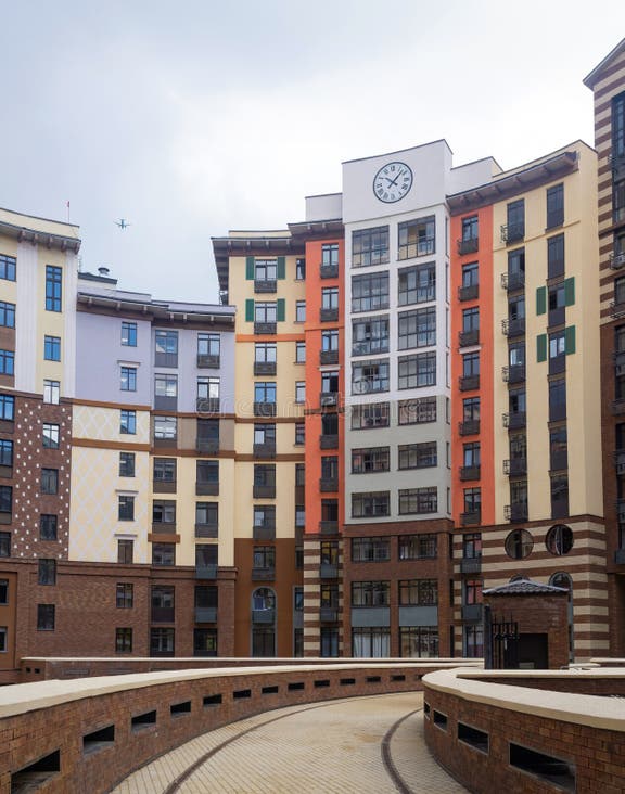 Multi-level Courtyard of a Modern Apartment Building with a Clock on ...