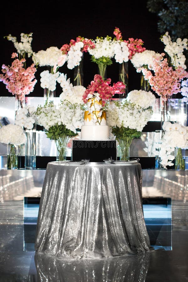 Multi Level Wedding Cake with Flowers on the Silver Table Stock Photo ...