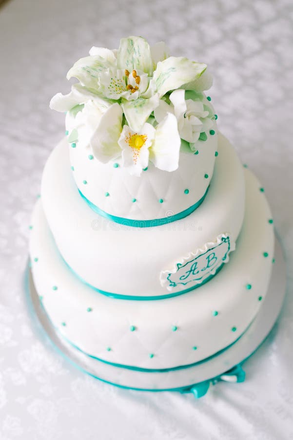 Multi-level White Wedding Cake and Beige Flowers on Top Stock Photo ...