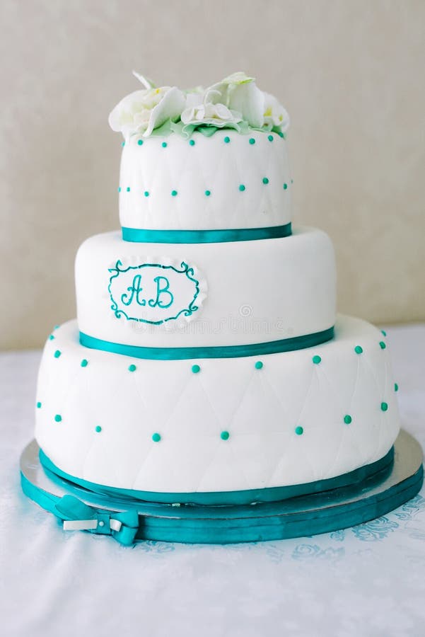 Multi-level White Wedding Cake and Beige Flowers on Top Stock Photo ...