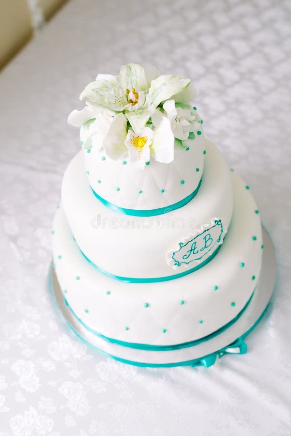 Multi-level White Wedding Cake and Beige Flowers on Top Stock Photo ...