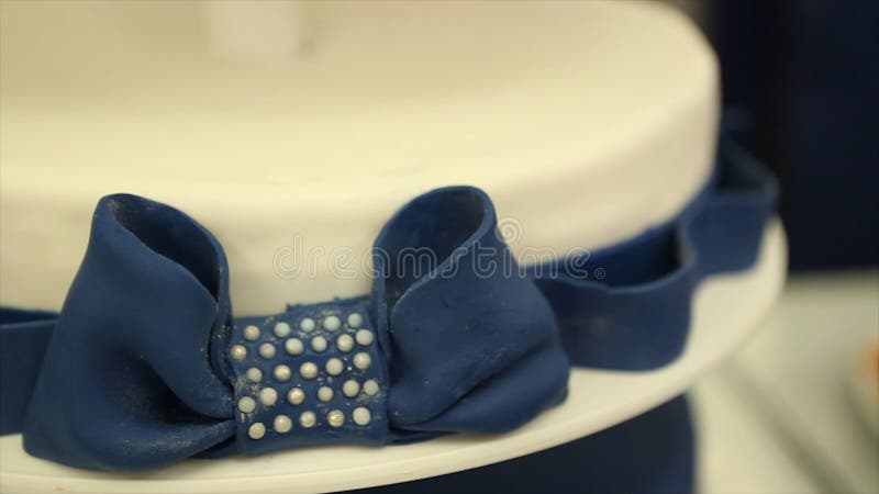 A Multi Level White Wedding Cake on a Silver Base and Pink Flowers on ...