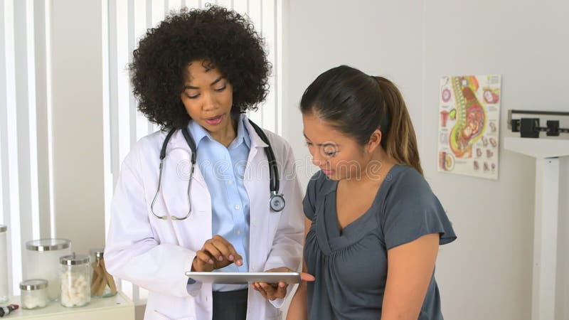 Multi-racial Doctor Patient Discuss Matters on a Tablet Stock Video ...