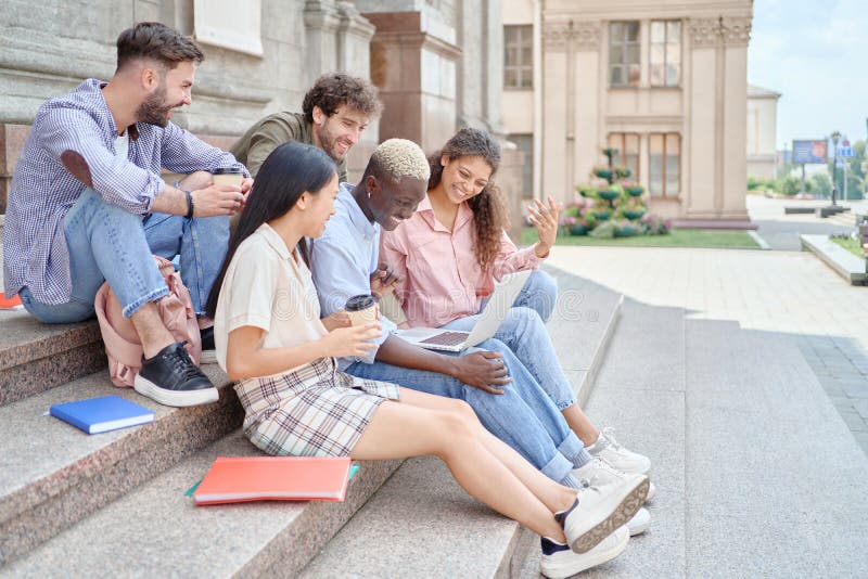 Multi-racial Group of Students Sitting on the Steps of the Campus ...