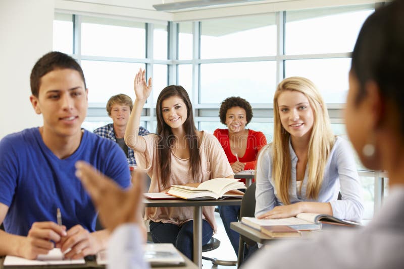 Multi Racial Teenage Pupils in Class One with Hand Up Stock Photo ...