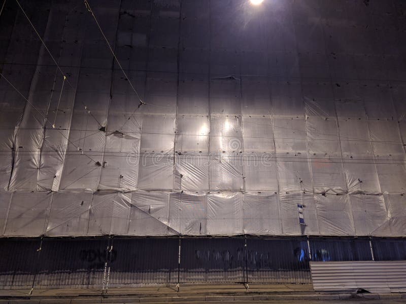 Multi Storey Building during Renovation Covered with Fabric at Night ...