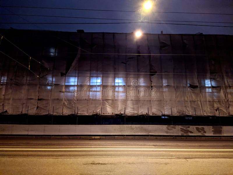 Multi Storey Building during Renovation Covered with Fabric at Night ...