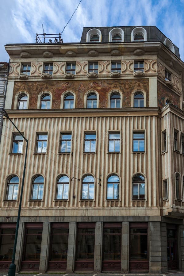 A Multi-story Building with a Decorated Facade Featuring Rows of Arched ...