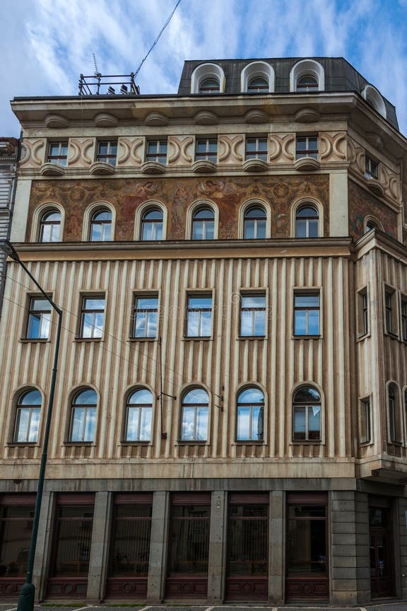 A Multi-story Building with a Decorated Facade Featuring Rows of Arched ...