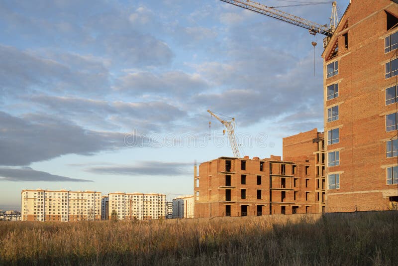 Multi-story Complex of Houses, Construction is Underway, Cranes are ...