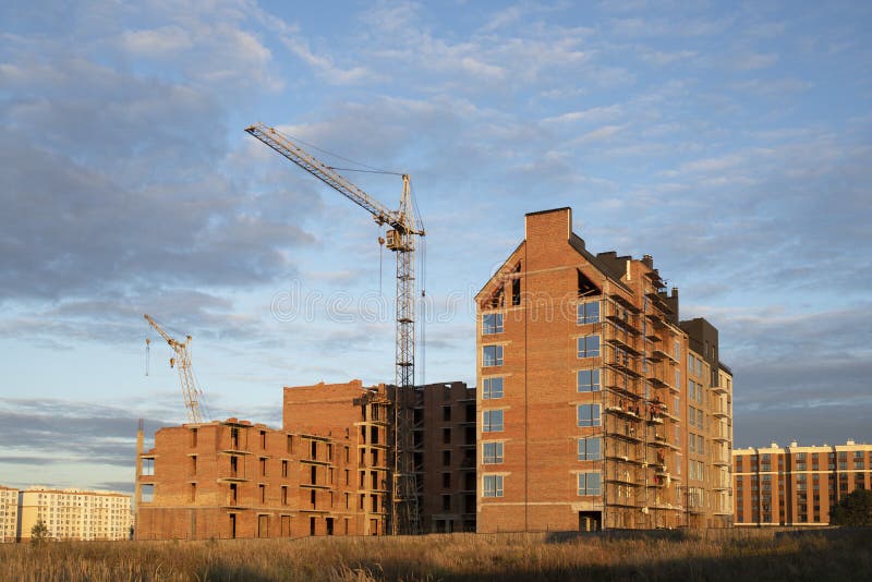 Multi-story Complex of Houses, Construction is Underway, Cranes are ...