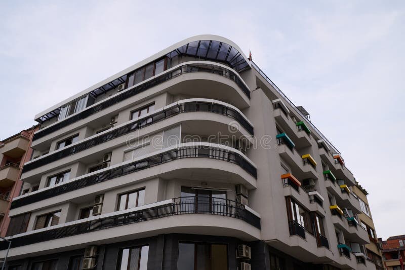 Modern Architectural Design Featuring a Curved Balcony in a Multi-story ...