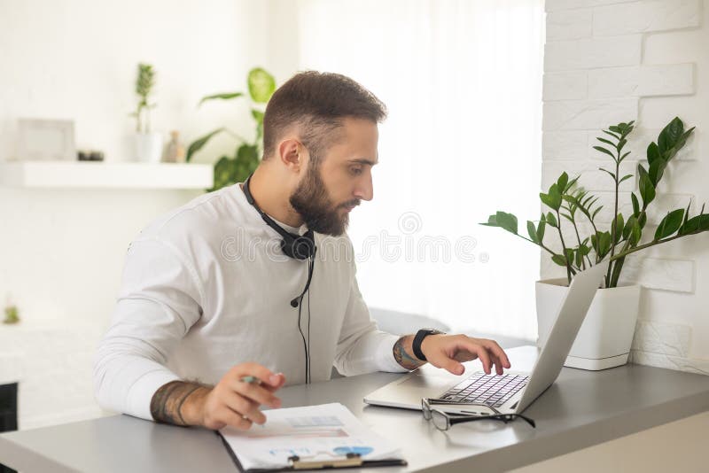 Multi-tasking Businessman Working in the Office. he is Using Touchpad ... Multi-tasking Businessman Working in the Office. he is Using Touchpad ...