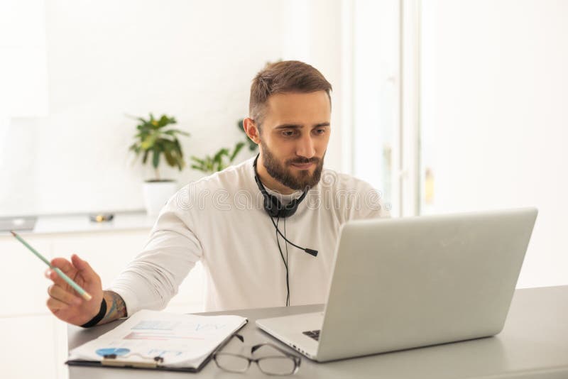 Multi-tasking Businessman Working in the Office. he is Using Touchpad ...