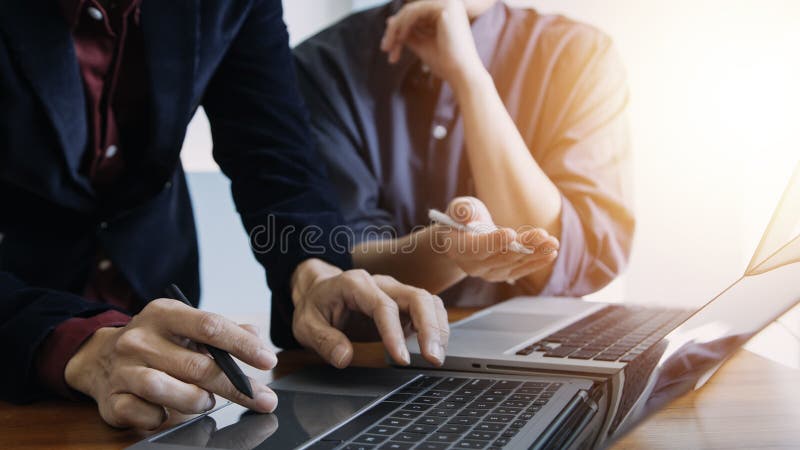 Multi-tasking Businessman Working in the Office. he is Using Touchpad ...