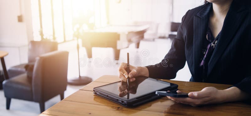 Multi-tasking Businessman Working in the Office. he is Using Touchpad ...