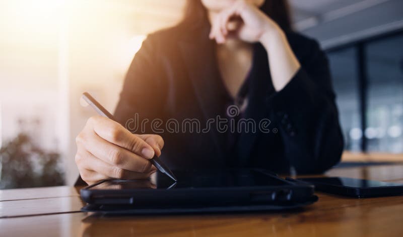 Multi-tasking Businessman Working in the Office. he is Using Touchpad ...
