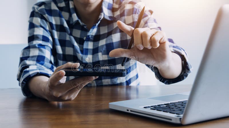 Multi-tasking Businessman Working in the Office. he is Using Touchpad ...