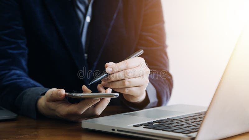 Multi-tasking Businessman Working in the Office. he is Using Touchpad ...