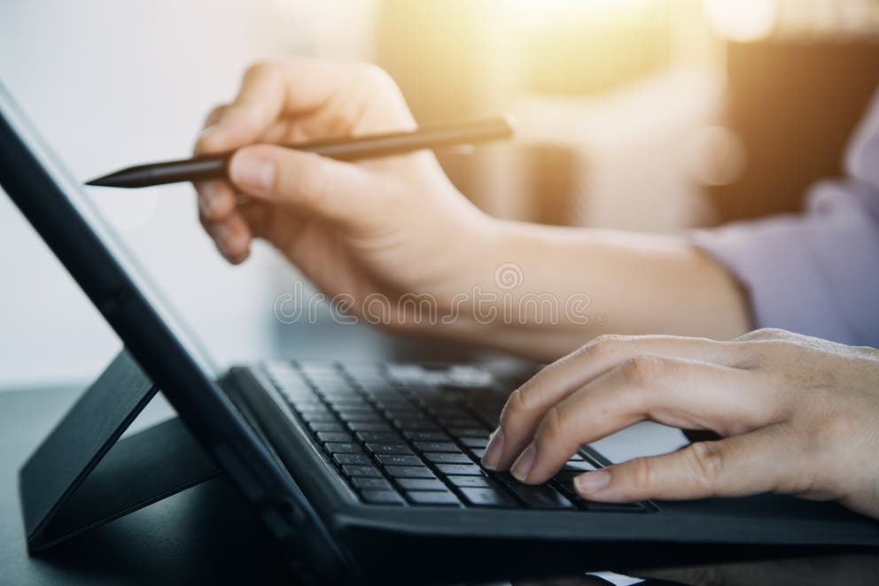 Multi-tasking Businessman Working in the Office. he is Using Touchpad while Reading an E-mail on ...
