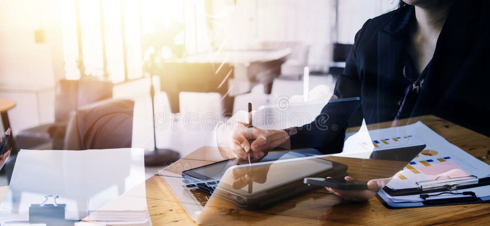 Multi-tasking Businessman Working in the Office. he is Using Touchpad while Reading an E-mail on ...