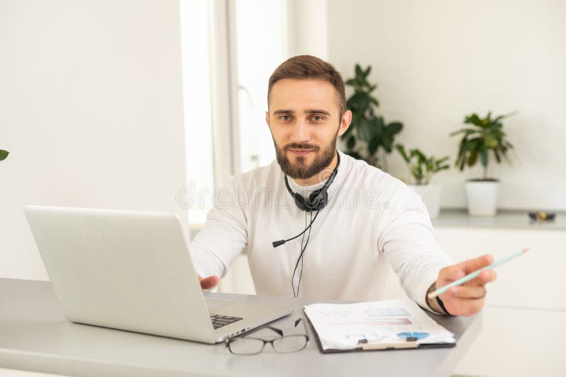Multi-tasking Businessman Working in the Office. he is Using Touchpad ... Multi-tasking Businessman Working in the Office. he is Using Touchpad ...