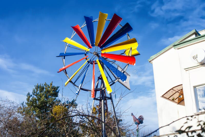 Multicolor Small Windmill by Blue Sky Near House Stock Photo - Image of ...
