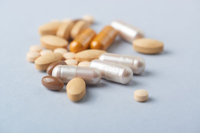 Multicolor Vitamins and Supplements on Bright Paper Background. Stock ...