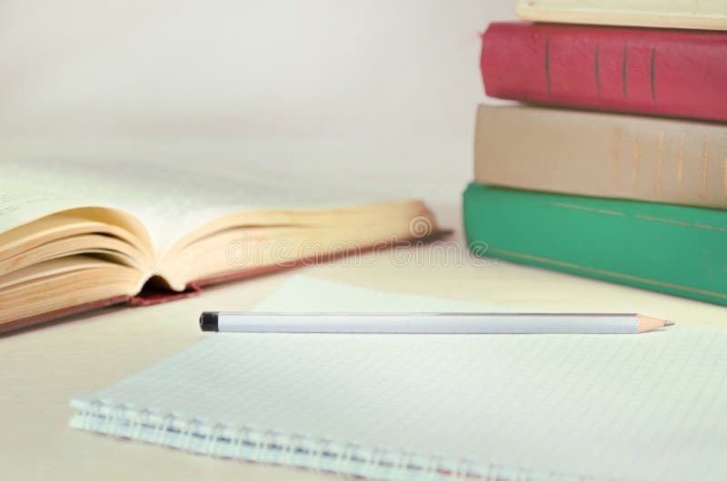 Multicolored Books, Stacked Up and an Open Book, Next To Notebook ...