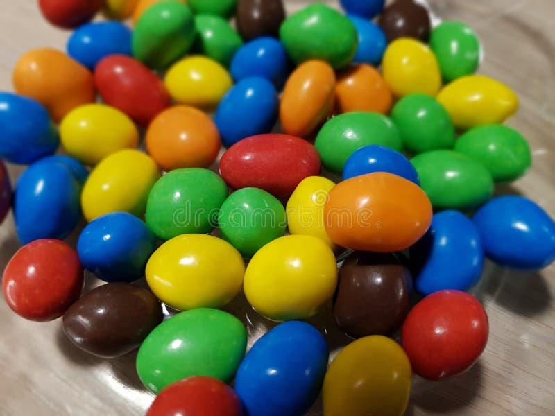 Multicolored Chocolate-covered Nuts in a Transparent Plate Stock Photo ...