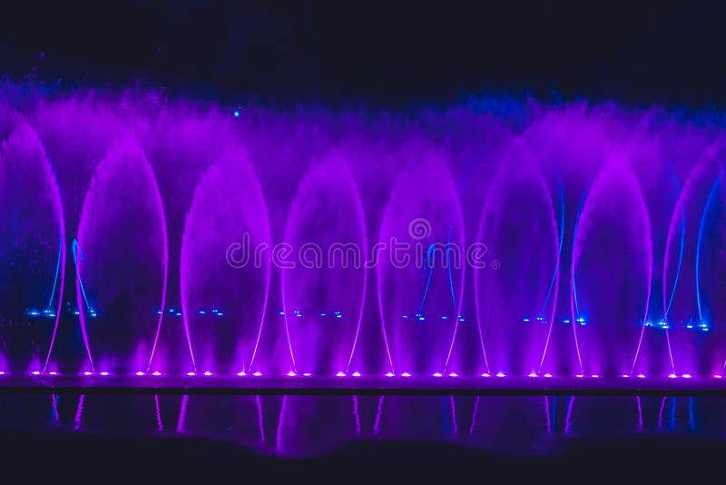 Multicolored Dancing Water Jet Fountain in the Dark Stock Photo - Image ...