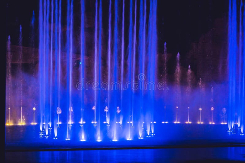 Multicolored Dancing Water Jet Fountain in the Dark Stock Photo - Image ...