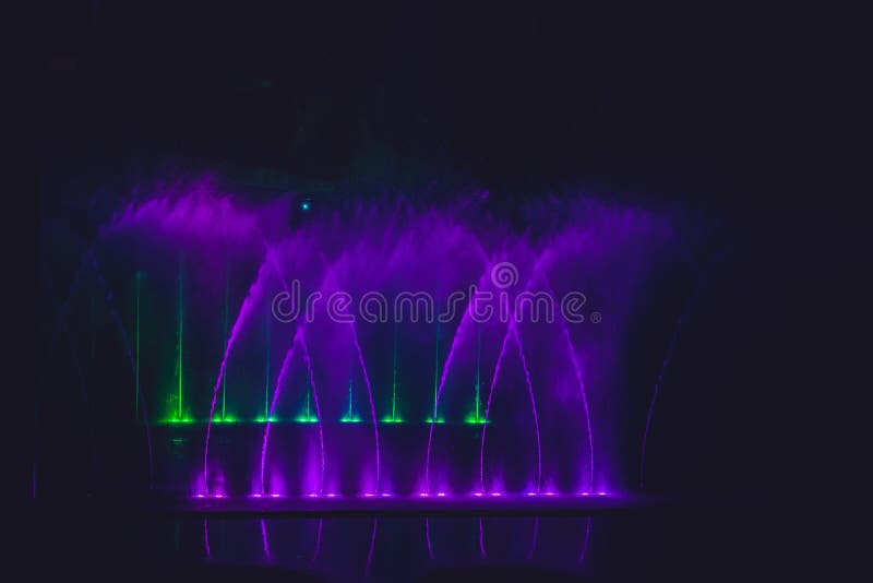 Multicolored Dancing Water Jet Fountain in the Dark Stock Image - Image ...