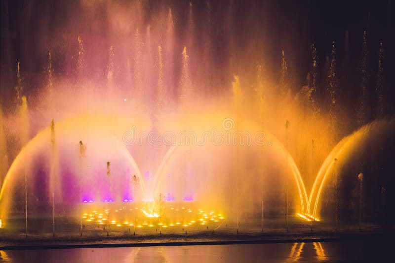 Multicolored Dancing Water Jet Fountain in the Dark Stock Image - Image ...
