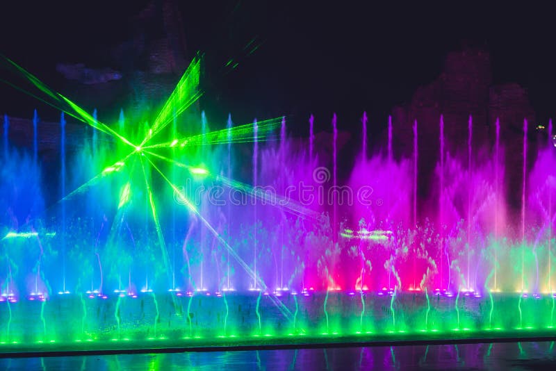 Multicolored Dancing Water Jet Fountain in the Dark Stock Image - Image ...