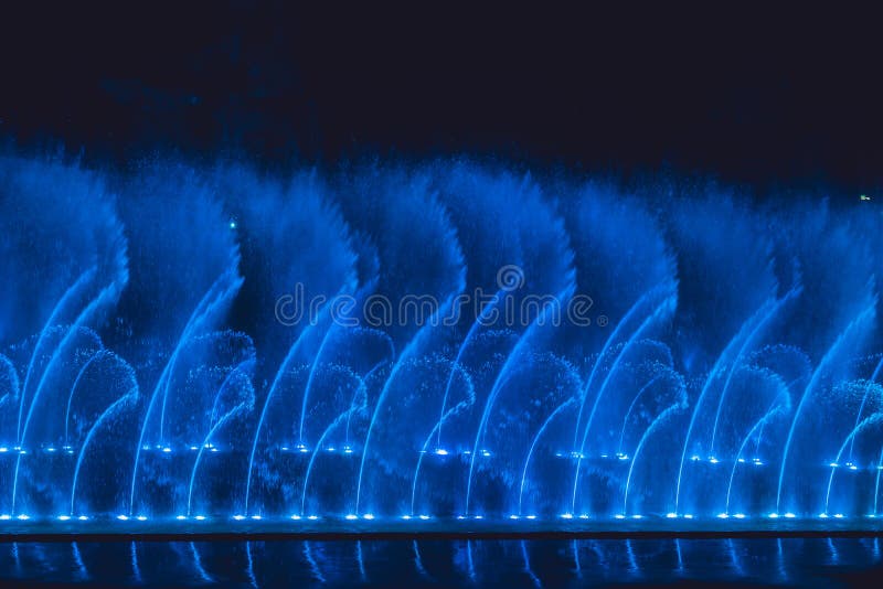 Multicolored Dancing Water Jet Fountain in the Dark Stock Image - Image ...