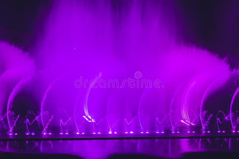 Multicolored Dancing Water Jet Fountain in the Dark Stock Image - Image ...