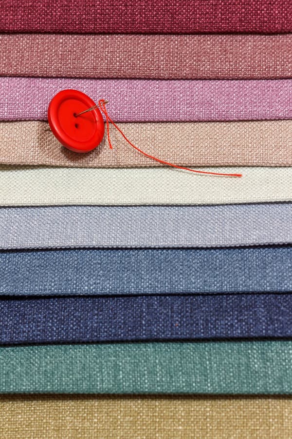 Multicolored Fabric Samples. Button with a Needle and Thread on the ...