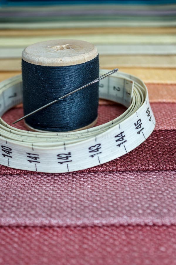 Multicolored Fabric Samples. a Button with a Needle and a Thread on the ...