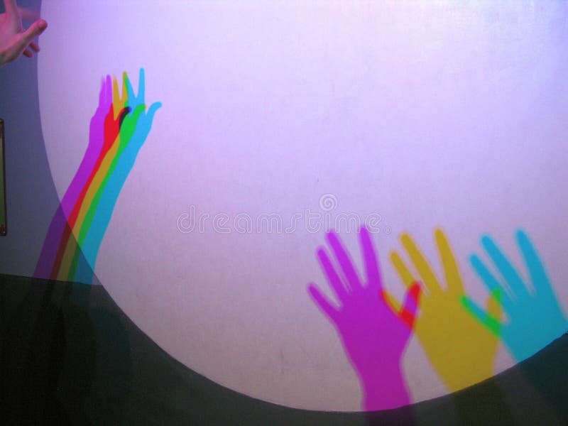 Multicolored Hand Shadows in Vibrant Hues Cast on a Curved Purple ...