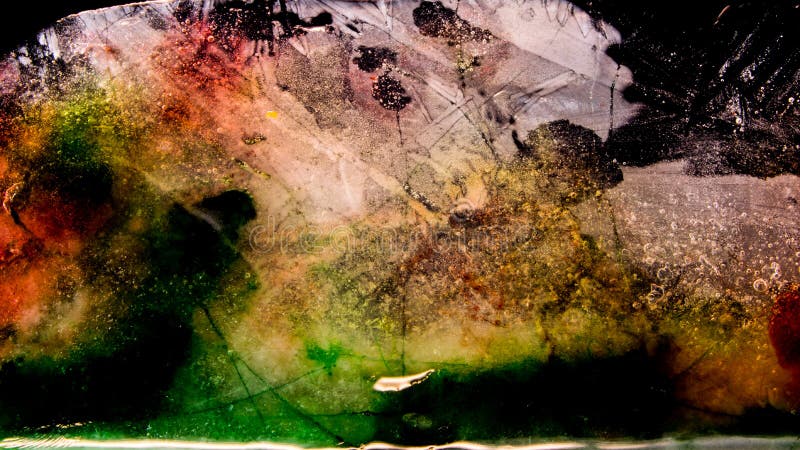 Multicolored Ice Plate Melting in Various Colors. Beautiful Ice ...
