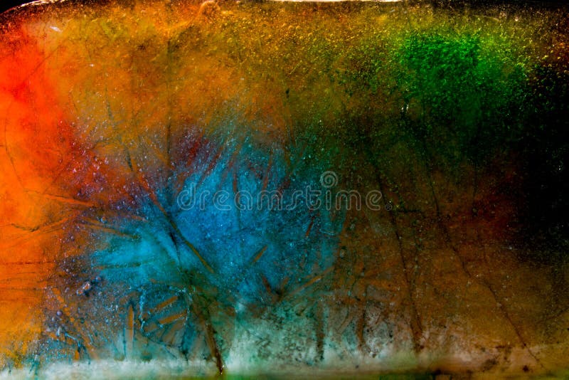 Multicolored Ice Plate Melting in Various Colors. Beautiful Ice ...