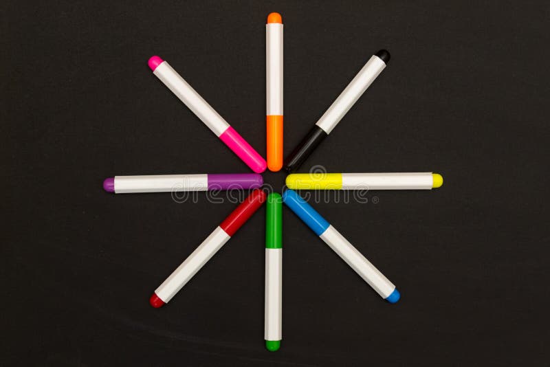 Multicolored Markers in the Shape of a Star on a Black Background ...