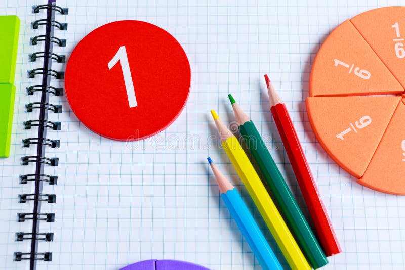 Multicolored Math Fractions on the Open Notepad on Gray Wooden Table ...